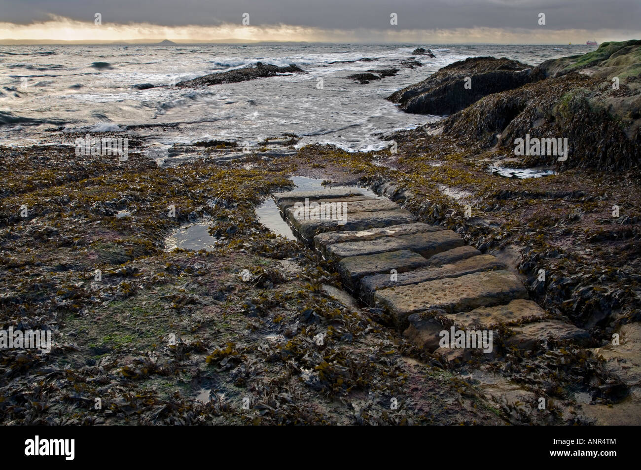 seashore showing inset slabs as a footway at Pittenweem Scotland Stock ...