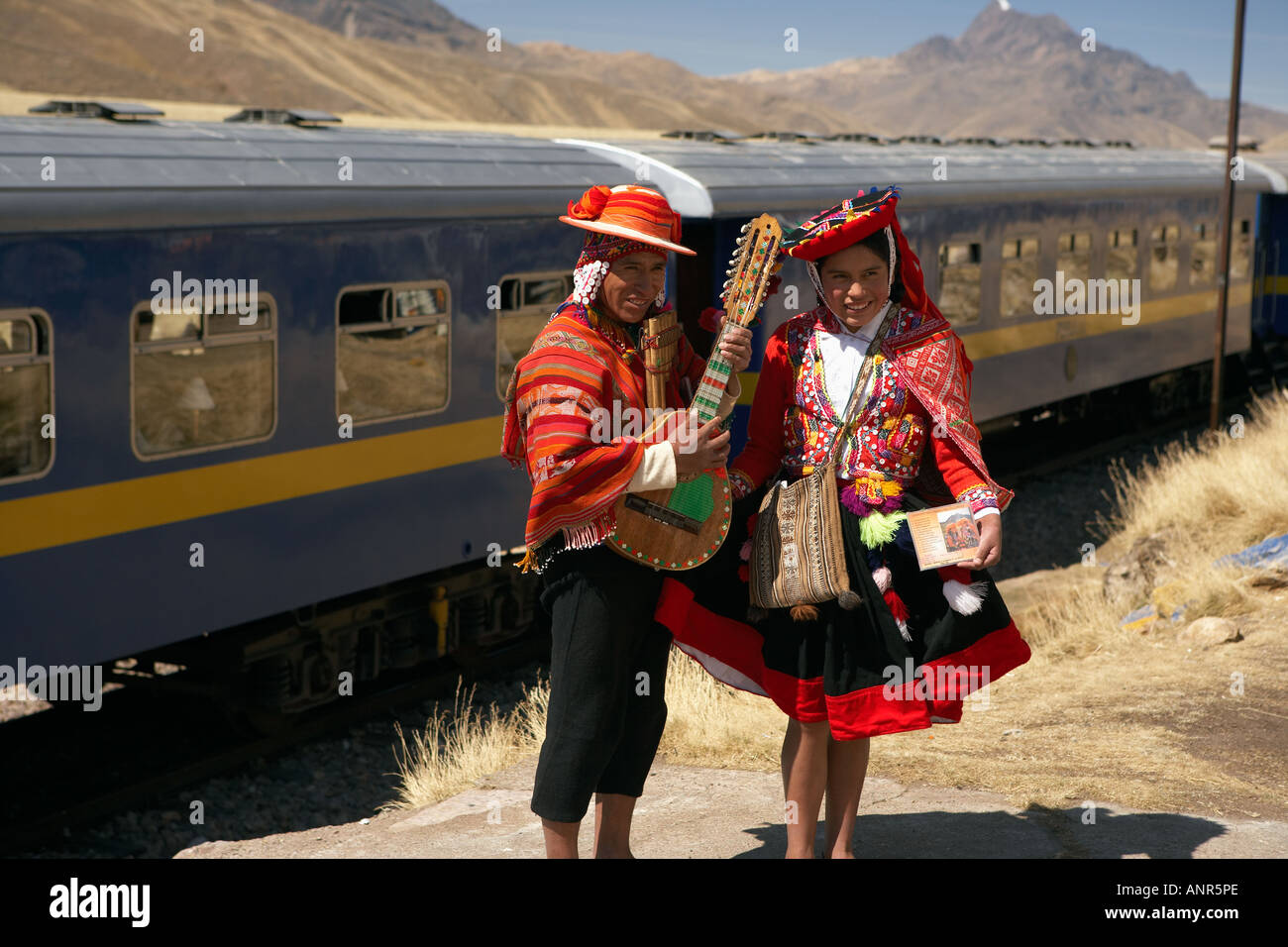 Entertainers pose outside the train from Cuzco to Puno Peru Stock Photo ...