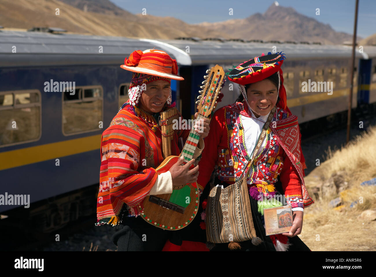 Entertainers pose outside the train from Cuzco to Puno Peru Stock Photo ...