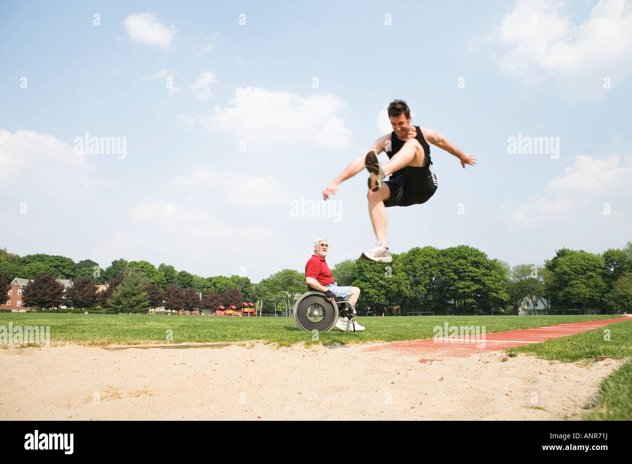 Young man practicing long jump Stock Photo - Alamy