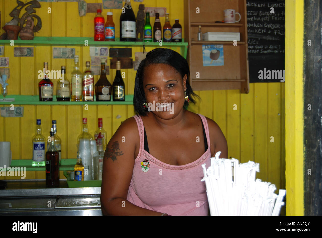 Woman behind bar on Long Bay Beach, Antigua, Caribbean Stock Photo - Alamy