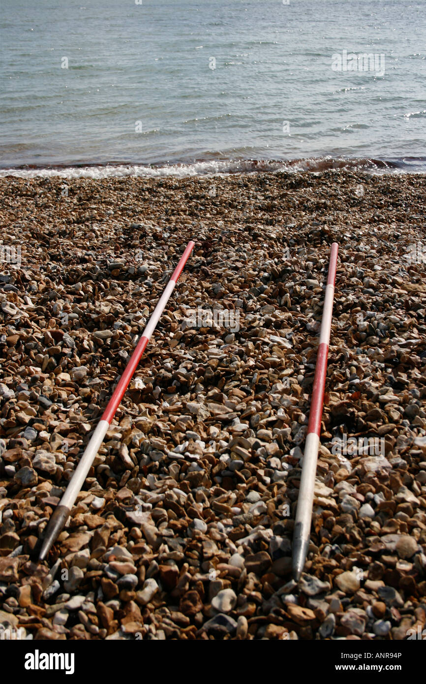 Ranging poles on Calshot Beach Stock Photo - Alamy