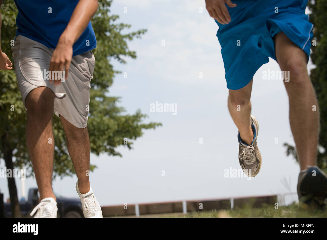 Low section view of two teenage boys running Stock Photo - Alamy