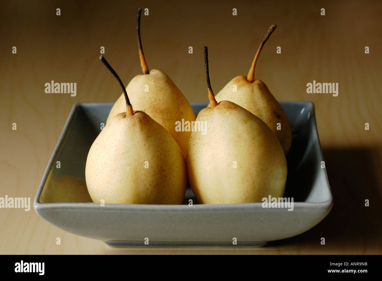 Nashi Asian or Sand Pears in square ceramic bowl on table Stock Photo ...