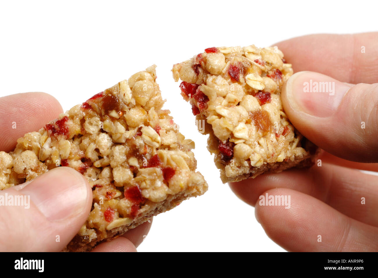 Fruit and cereal healthy snack bar being broken by man Model Released ...