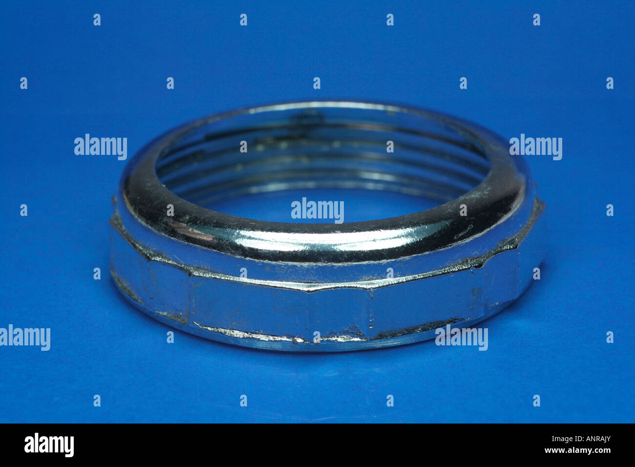 Metal nut used to connect a drain Stock Photo - Alamy