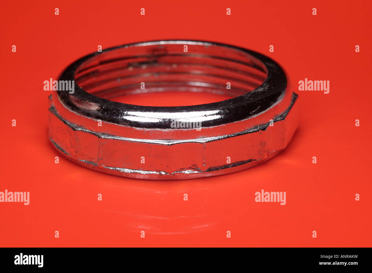Metal nut used to connect a drain Stock Photo - Alamy