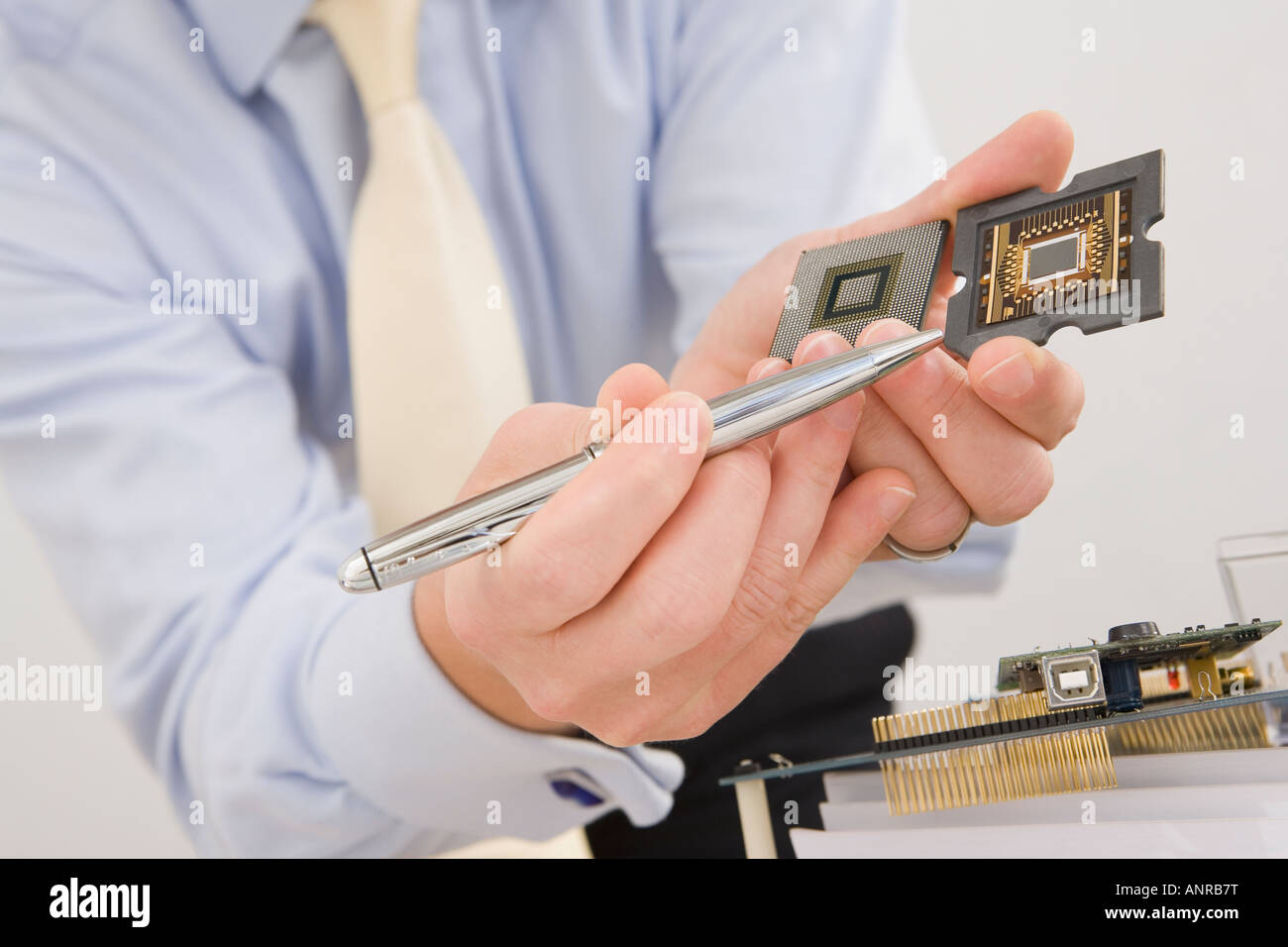 Mid section view of a businessman showing a computer chip Stock Photo ...