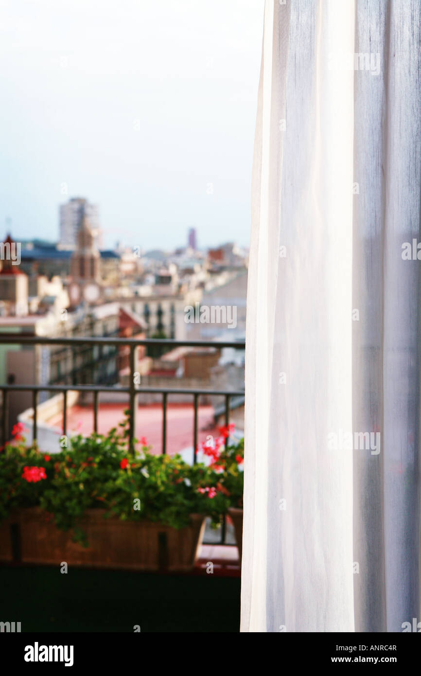 Looking out across Barcelona skyline from a rooftop balcony with warm ...