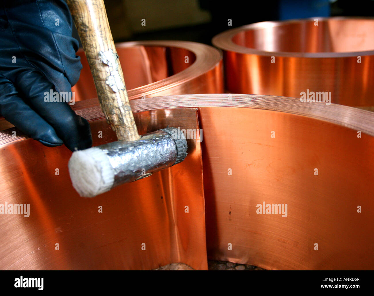 A hammer on Copper Stripping Coil Stock Photo - Alamy