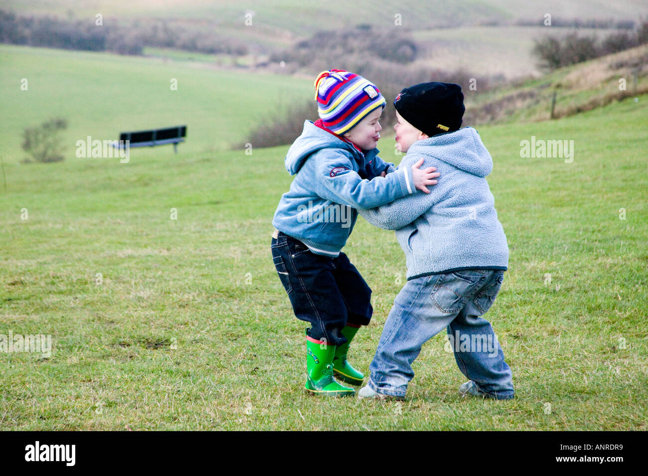 Fighting boys pushing playground hi-res stock photography and images ...
