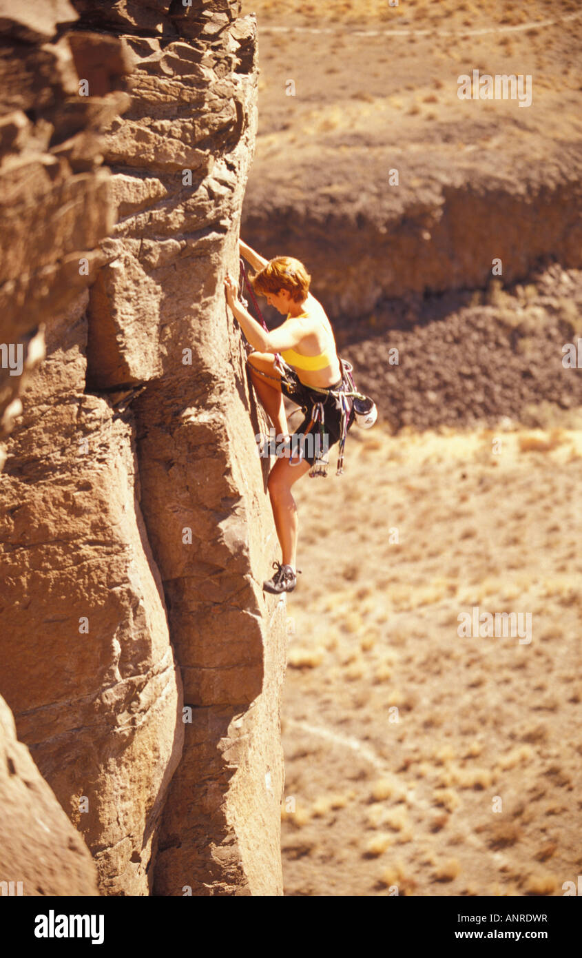 A young woman rock climber carefully selects another toehold Stock ...