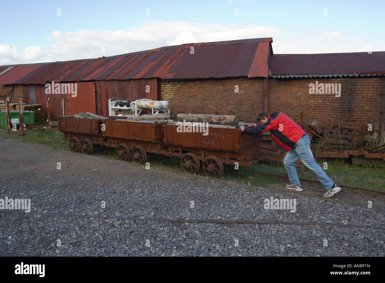 Man pushing rusty tubs. Big Pit. National Mining Museum of Wales ...
