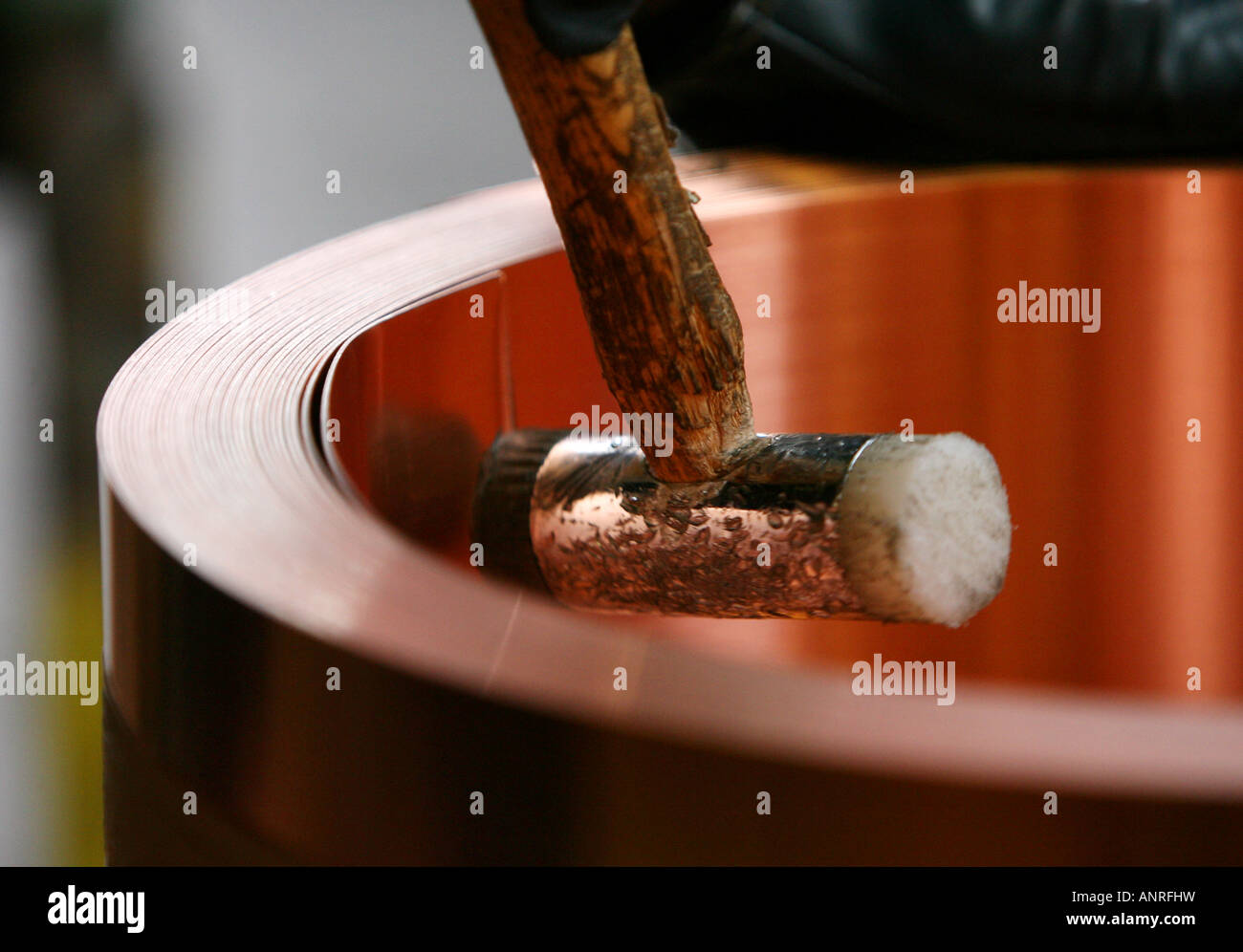 A hammer on Copper Stripping Coil Stock Photo - Alamy