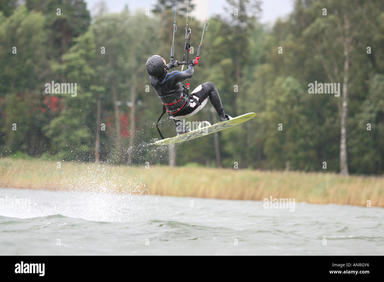 Kitesurfer jumping over water Stock Photo - Alamy