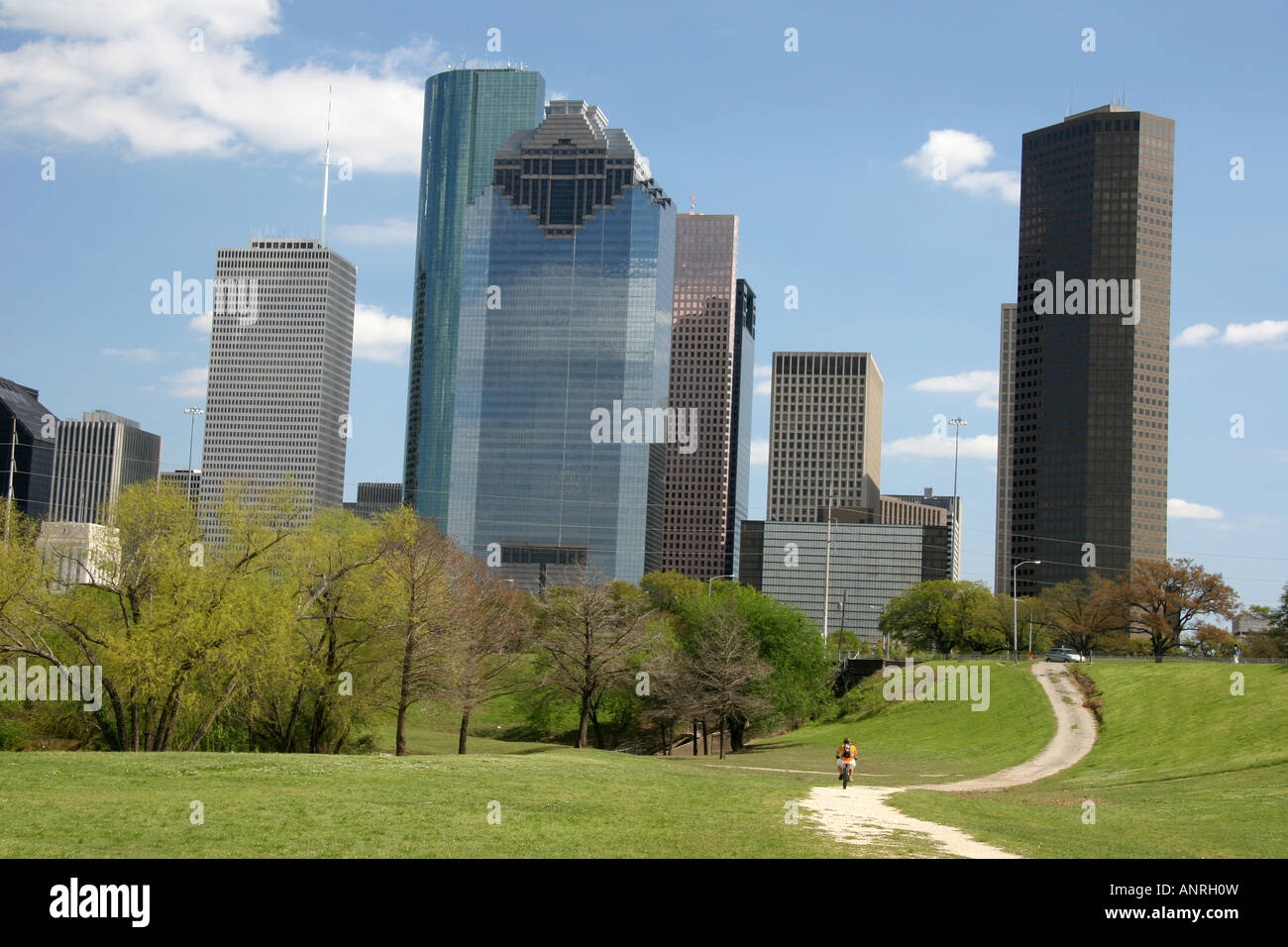Path in park leading to city skyline bike visible on path Stock Photo ...