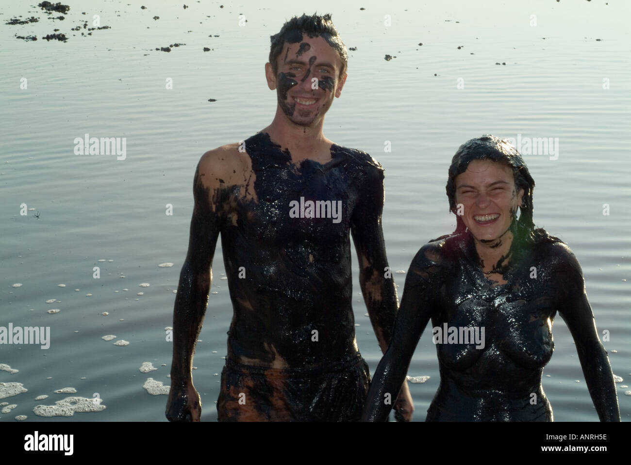 Young couple covered in mud, coming out of salt panes lake,Burgas ...