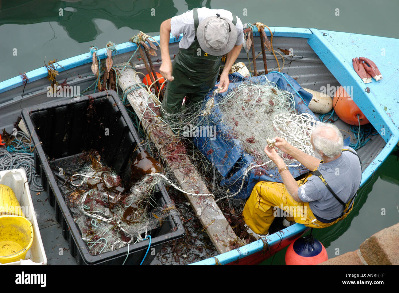 fishermen repairing and maintaining their nets Stock Photo - Alamy