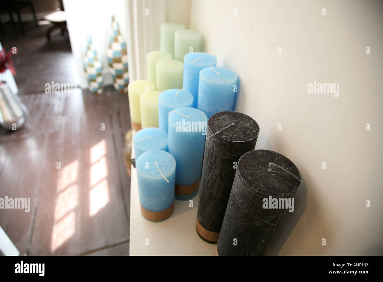 Coloured candles on a shelf Stock Photo - Alamy