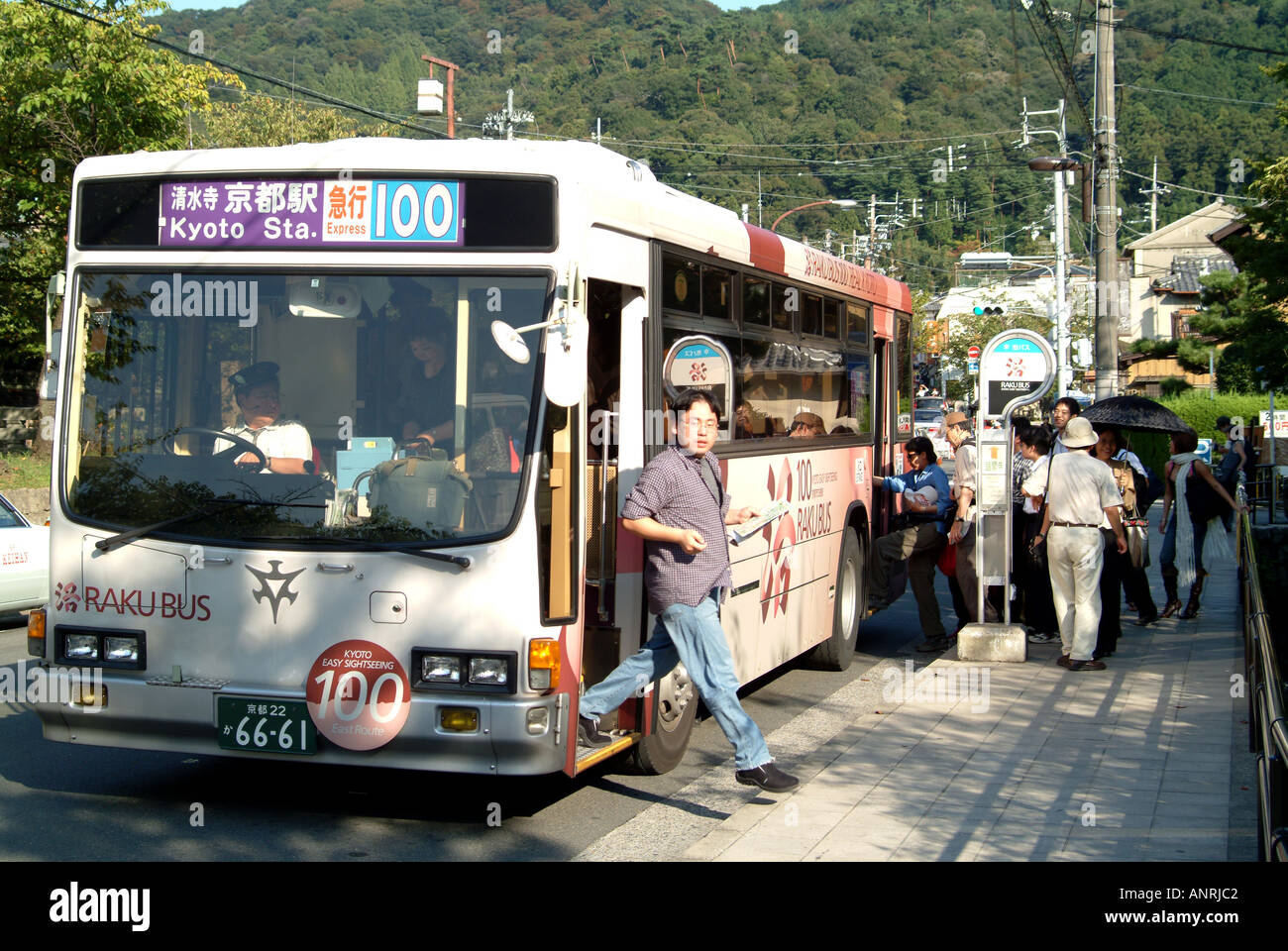 Passengers and the 100 Raku bus Gingkakuji Kyoto Japan Stock Photo - Alamy