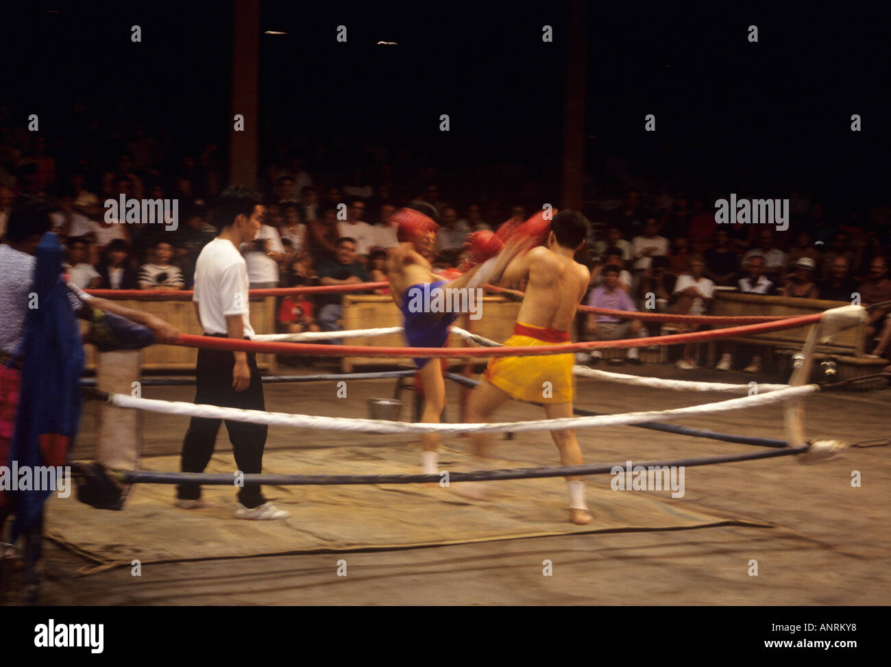 A kick boxer aims a high kick towards his opponent s head during a kick ...