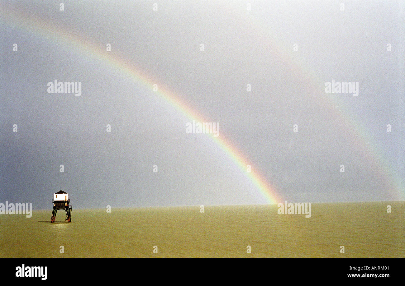 rainbow at sea with lighthouse after a summer storm Stock Photo - Alamy