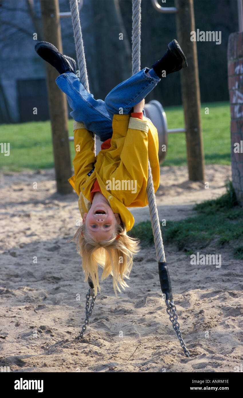 Girl hanging on a rope head down Stock Photo - Alamy