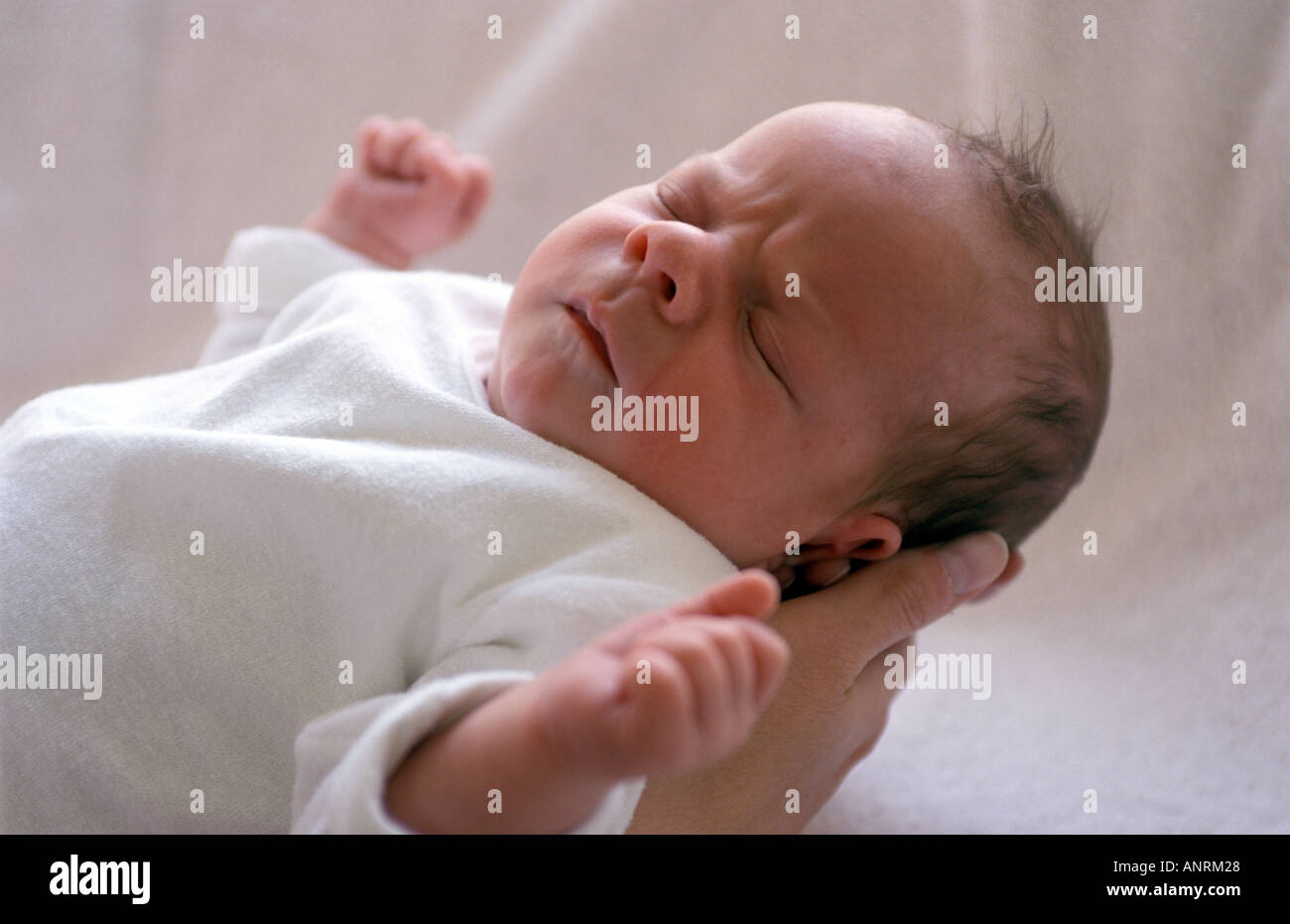 Portrait of a newborn baby with a disturbed expression Stock Photo - Alamy