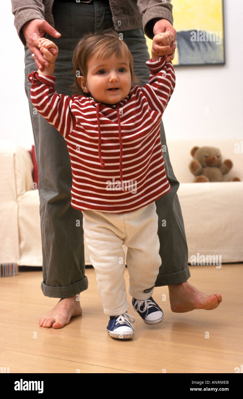 Baby first steps Stock Photo - Alamy