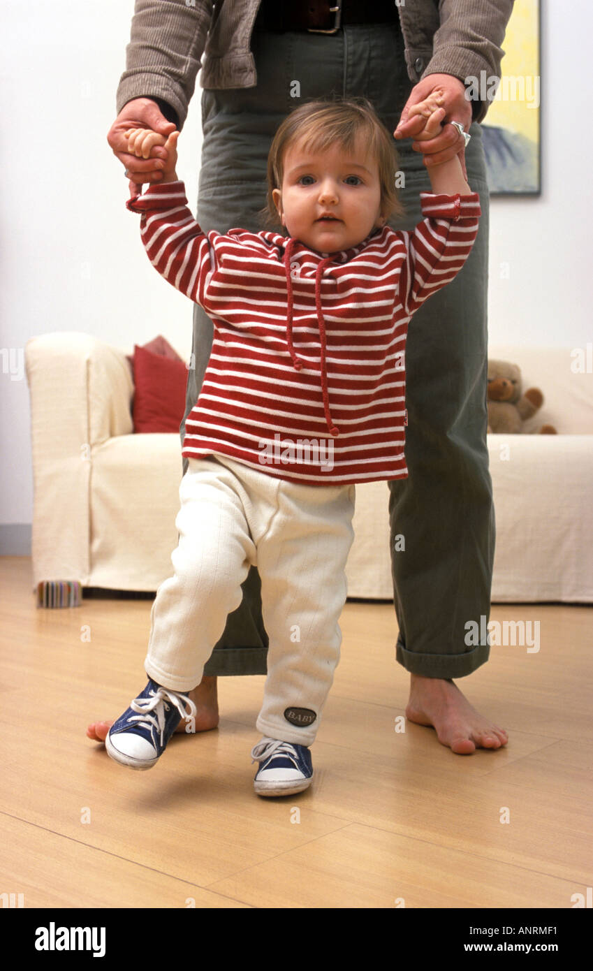 Baby first steps Stock Photo - Alamy