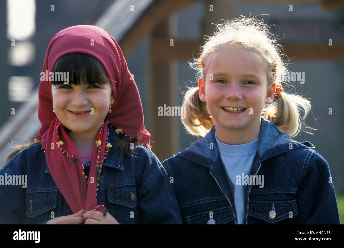 Two girls of a different culture Stock Photo - Alamy