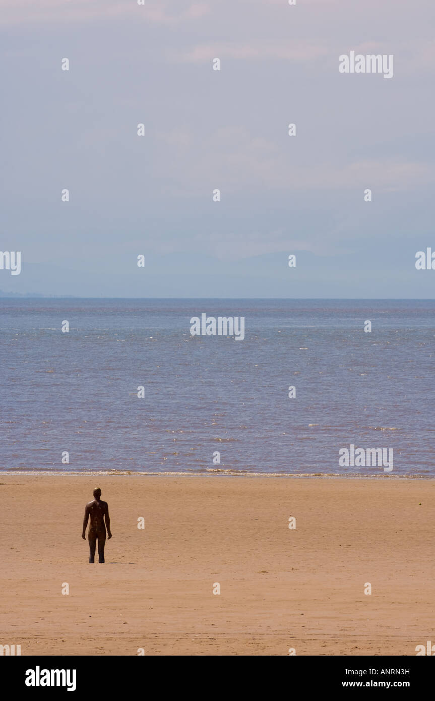 Iron Man sculpture on the soft sand of Crosby Beach looking out to sea ...