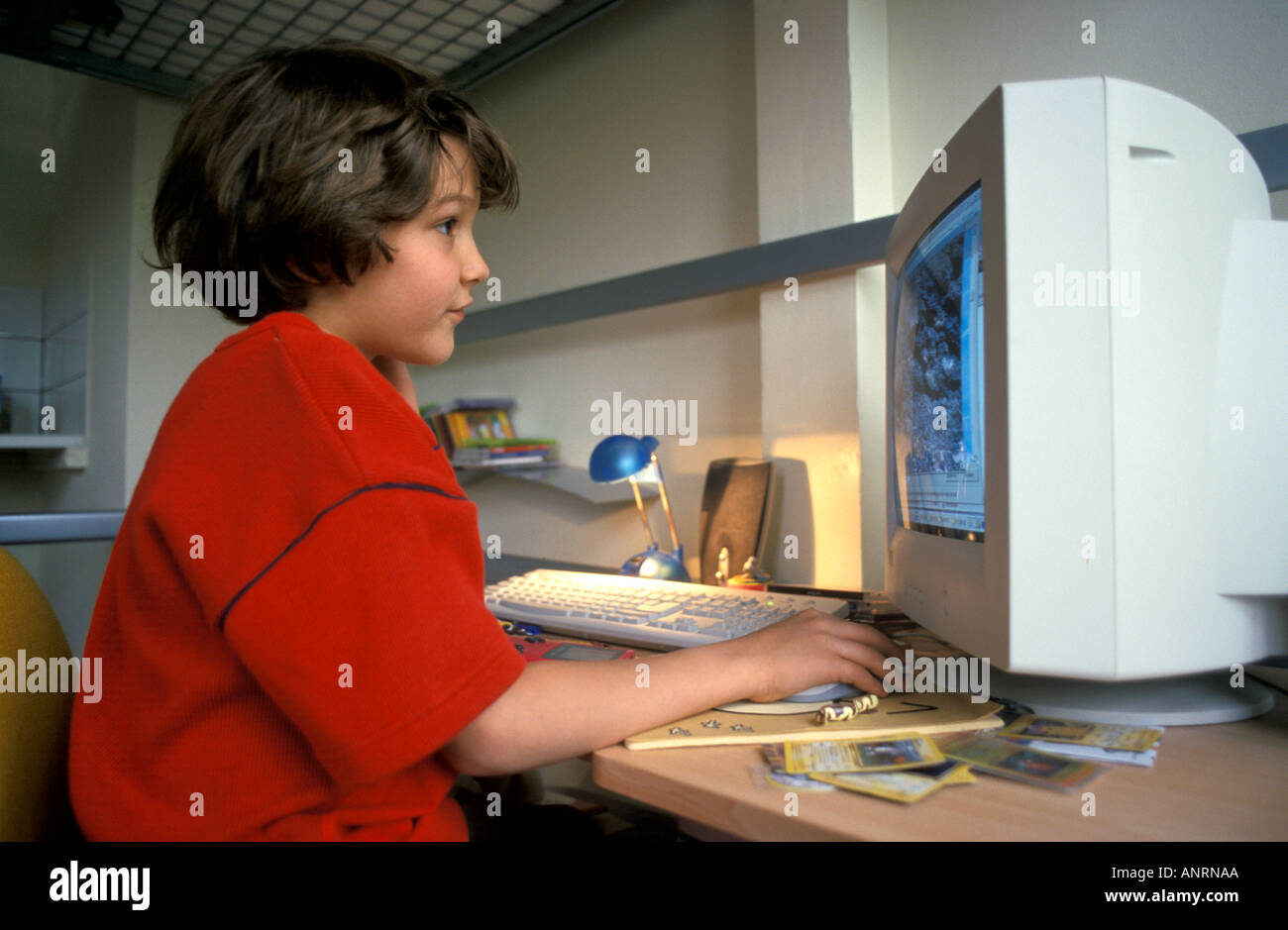 Boy playing games at computer Stock Photo - Alamy