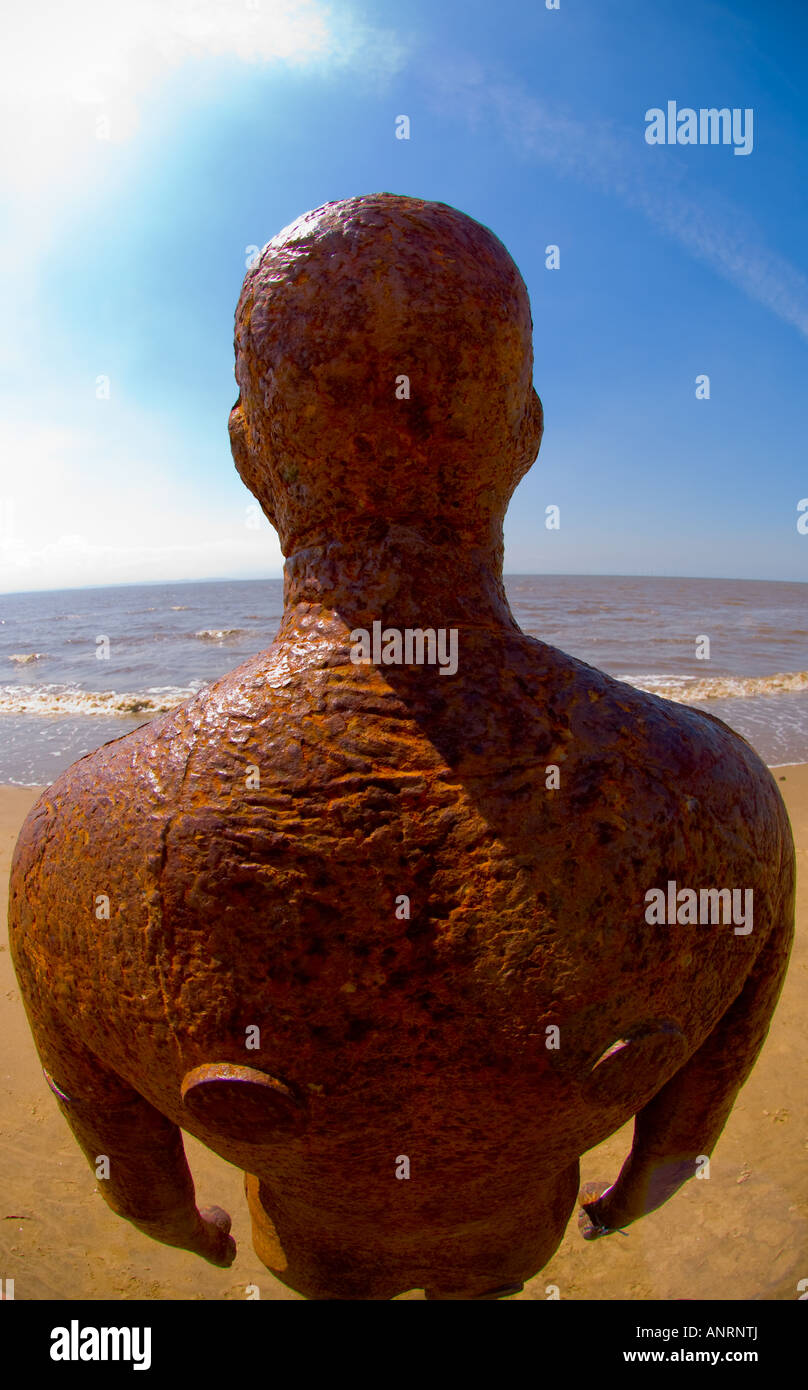 Another Place by Antony Gormley. Rear view of rusty cast iron man ...