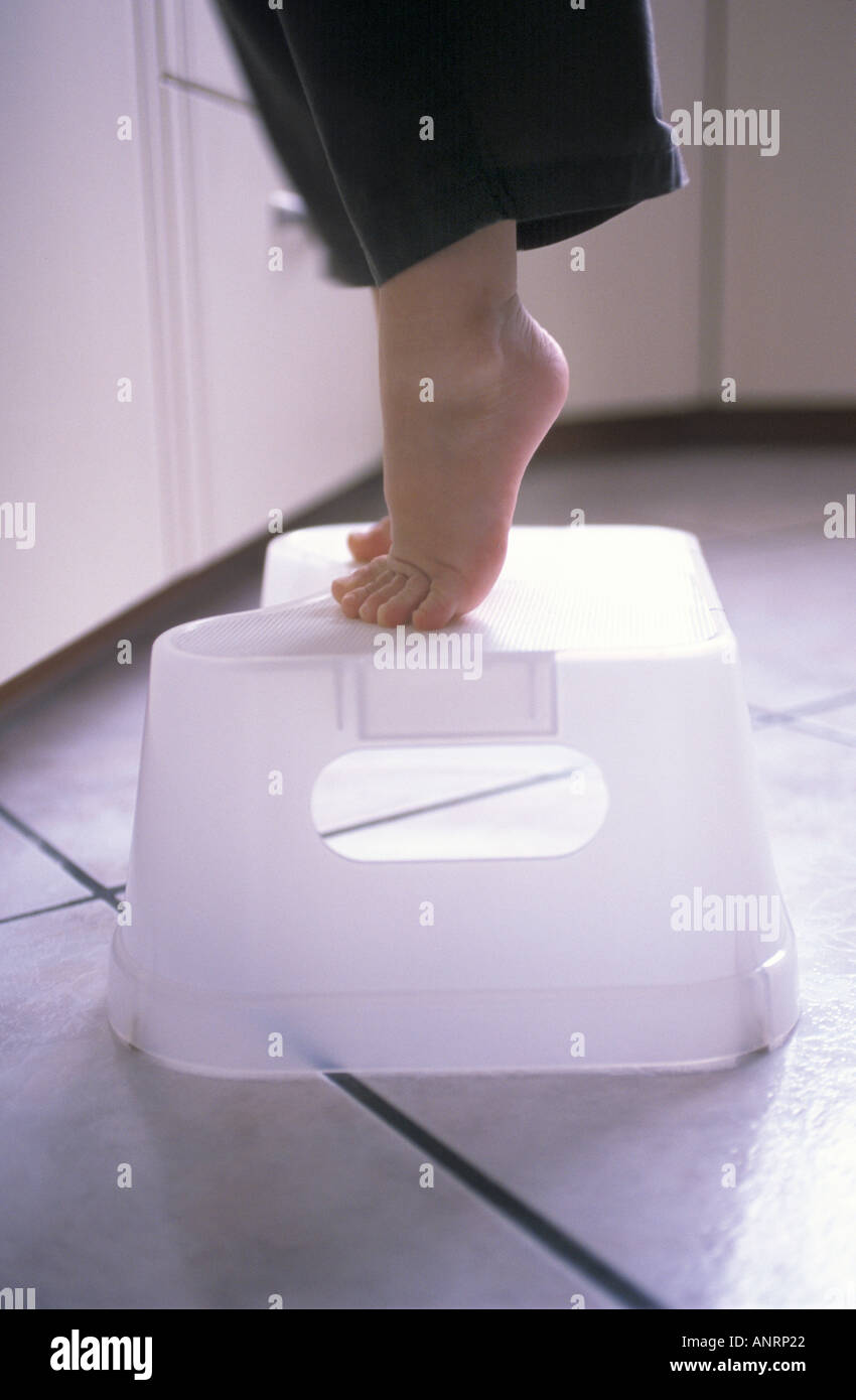 Child standing on his her toes on a step Stock Photo - Alamy