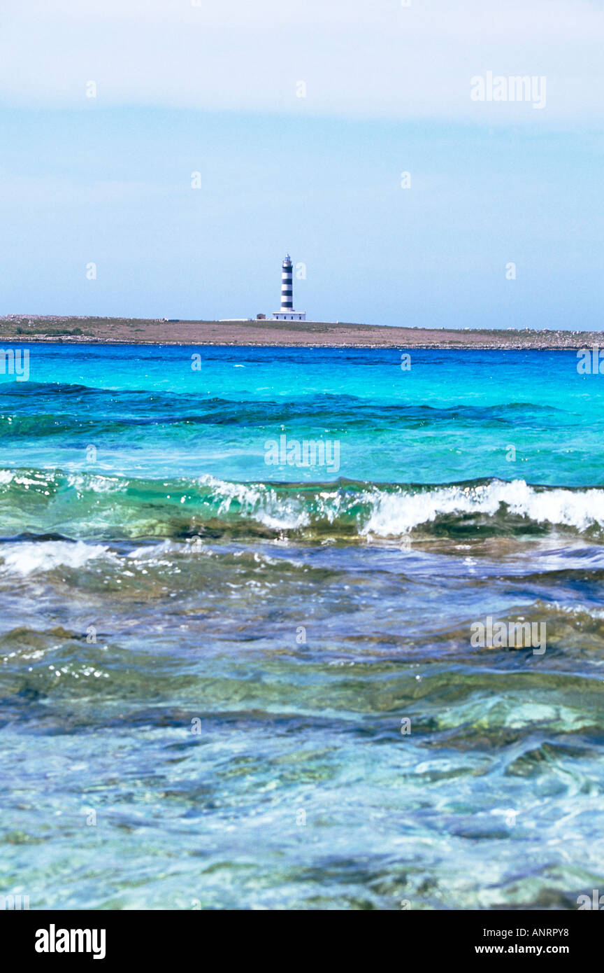 Clear waters lap the shores at Punta Prima with a large striped ...