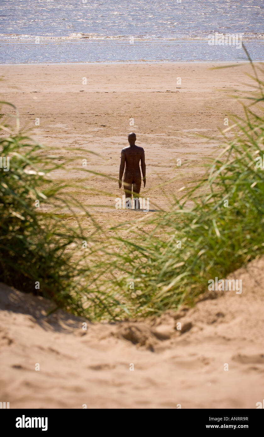 An iconic Another Place, cast Iron Man statue stands amidst the sand ...