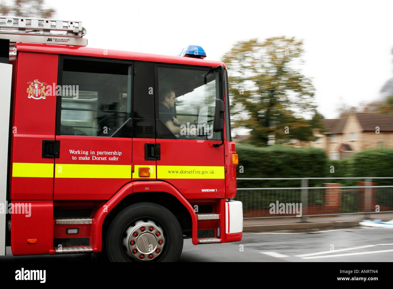 Fire engine racing to incident, Poole, Dorset, England, UK Stock Photo ...