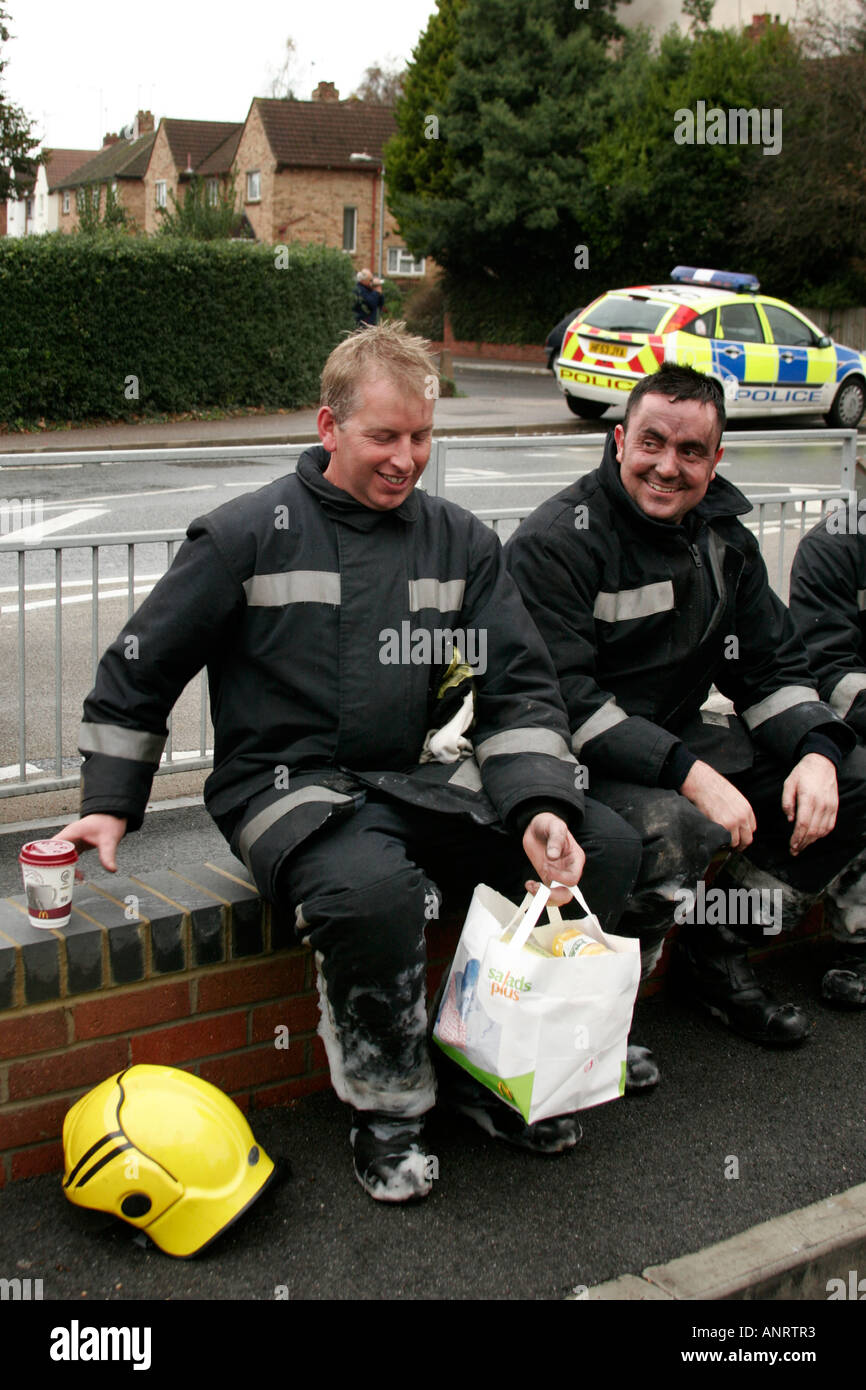 Firemen on duty breaking for takeaway lunch Stock Photo - Alamy