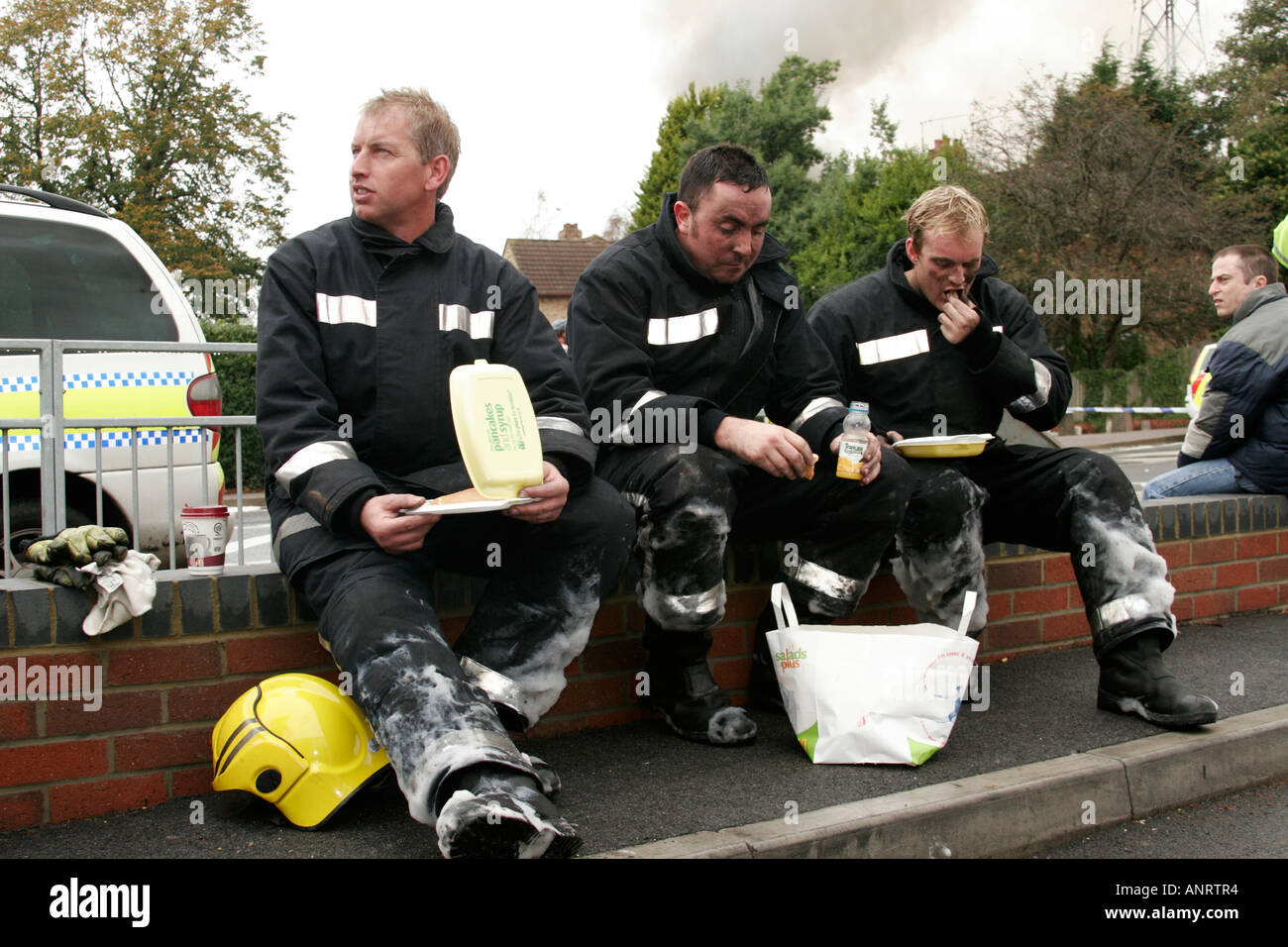 Firemen on duty stopping for takeaway lunch Stock Photo - Alamy