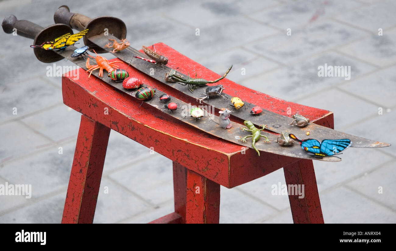 Ancient swords covered with plastic insects at chinese market Stock ...