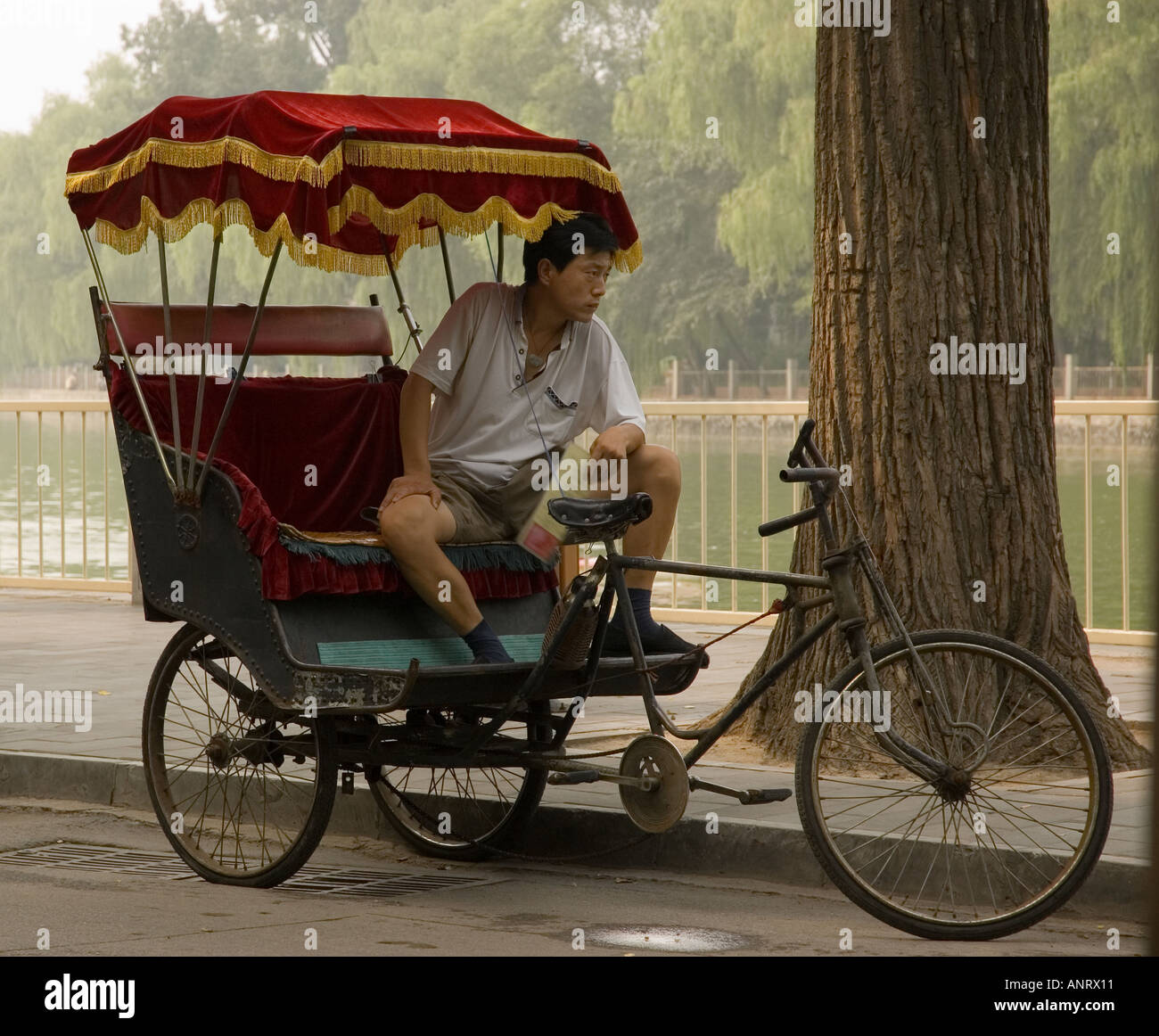 Bicycle rickshaw driver on a break in Beihai park, Beijing, China Stock ...