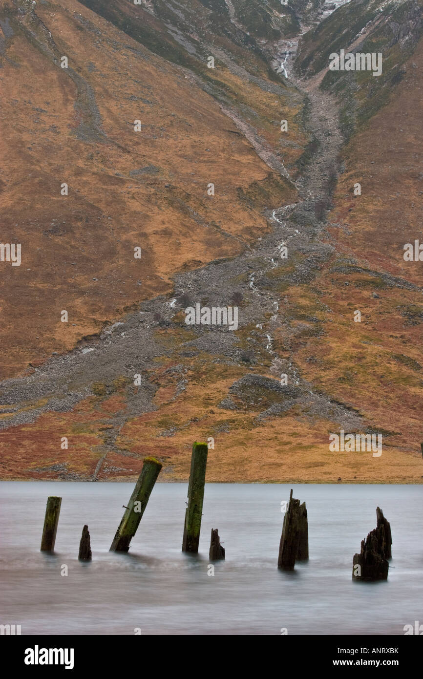 Posts from a decaying pier in Loch Etive, Scotland Stock Photo - Alamy