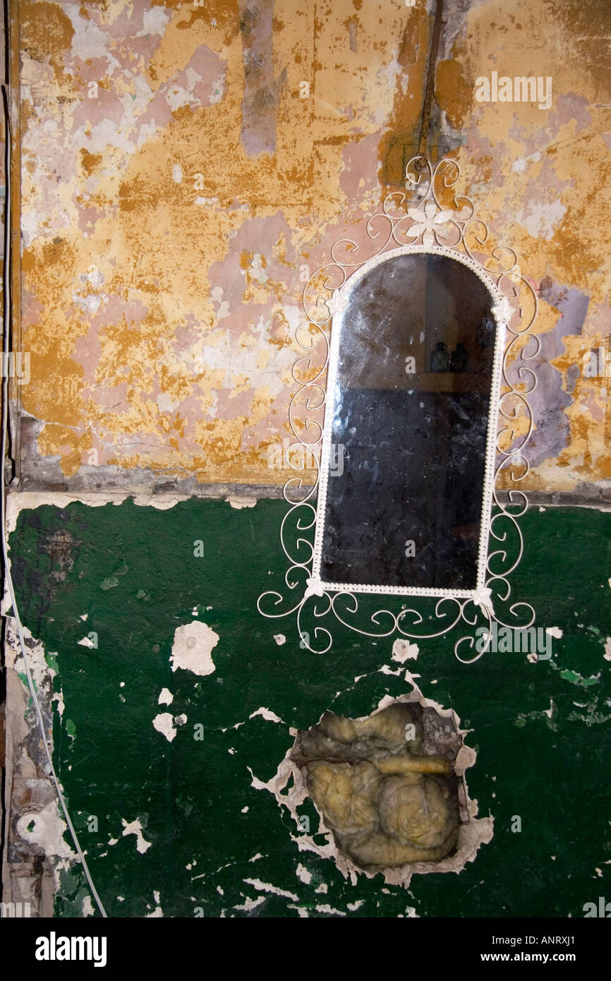 close up abstract view of a wall with peeling paster coloued paint ...