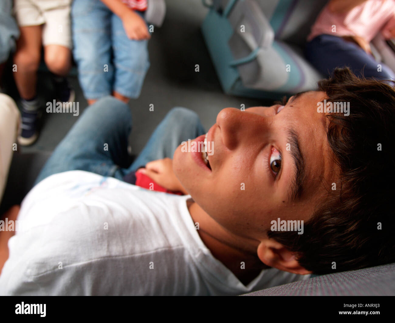 boy looks over shoulder at camera above Stock Photo - Alamy