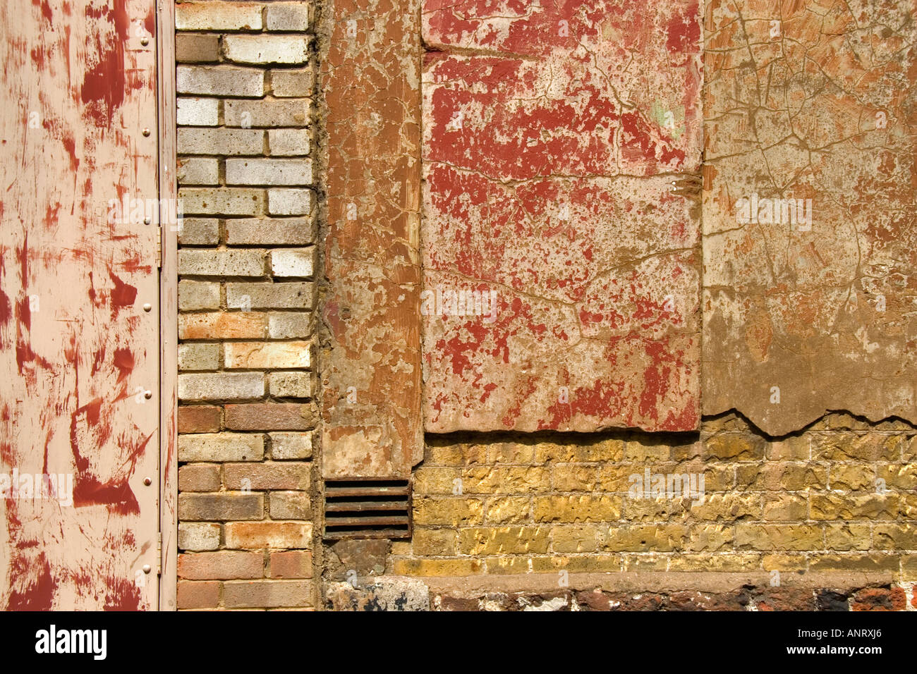 an abstract view of a dilapidated brick wall with crumbling cement and ...