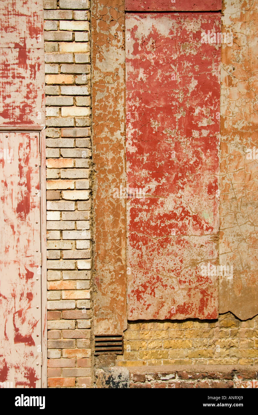 an abstract view of a dilapidated brick wall with crumbling cement and ...