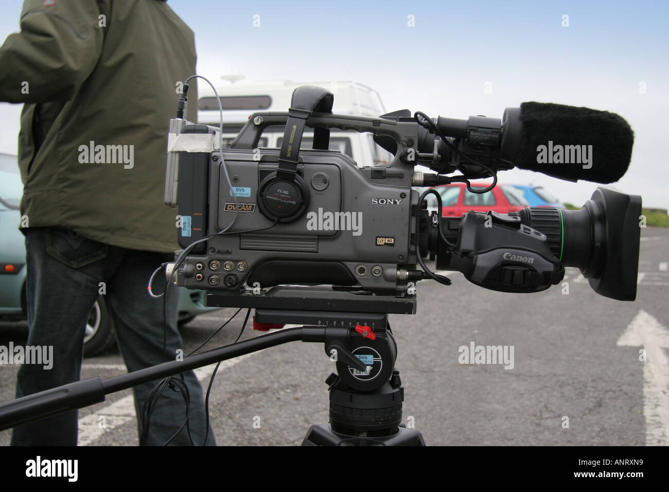 A side view of a professional video camera Cameraman is in background ...