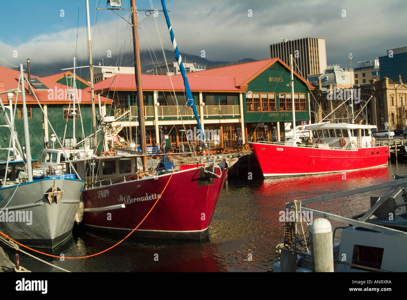Fishing boats moored below Mures Fish restaurant in Victoria Dock ...