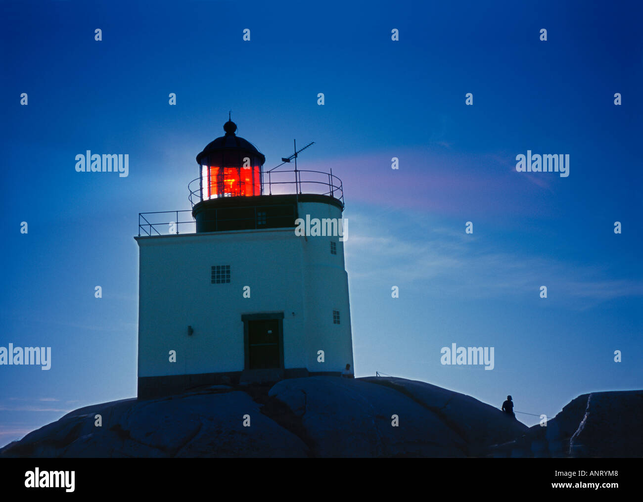 Lighthouse on rock Stock Photo - Alamy